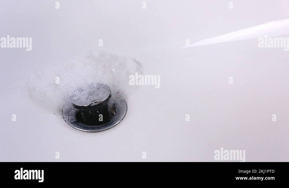 Foam in water drain hole in a wash basin disappearing time lapse Stock ...
