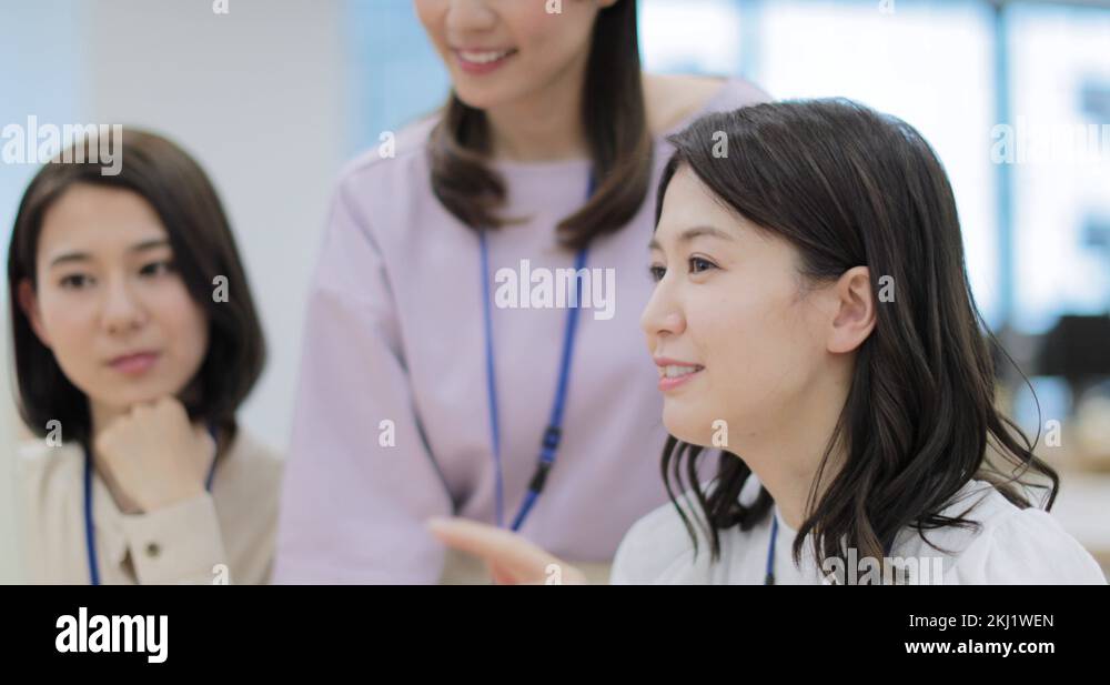 Team of Japanese businesspeople working together in the office Stock ...
