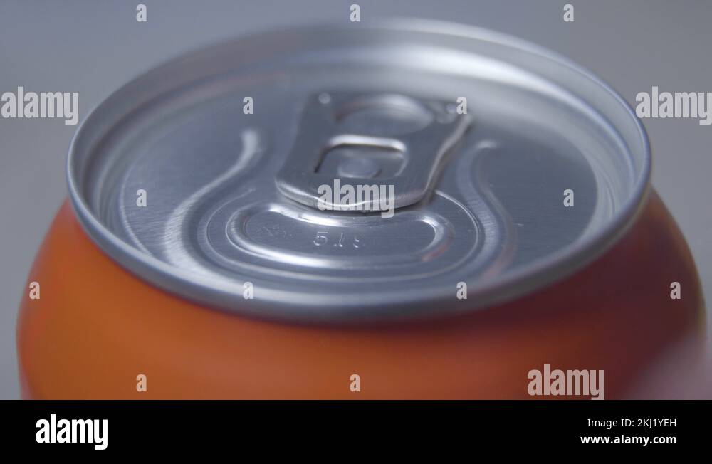 Extreme close-up of male Caucasian hand opening can of beer or ...