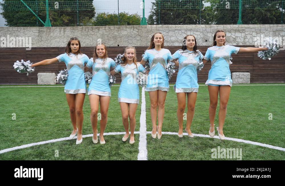 Youth Girls In Cheerleader In Uniform With Pom Poms Making Gymnastic Movements Stock Video