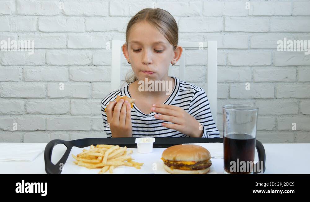 Kid Eating Fast Food, Child Eats Hamburger in Restaurant, Girl Drinking ...