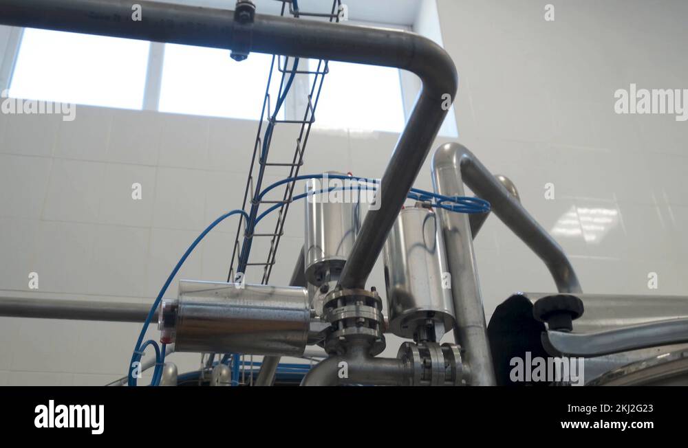 Parts of a machine at factory.Metal pipes are intertwined and fixed ...