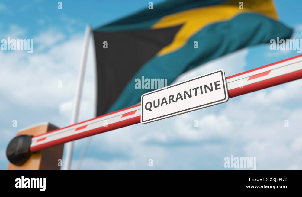 Open boom gate with QUARANTINE sign on the Bahamian flag background ...