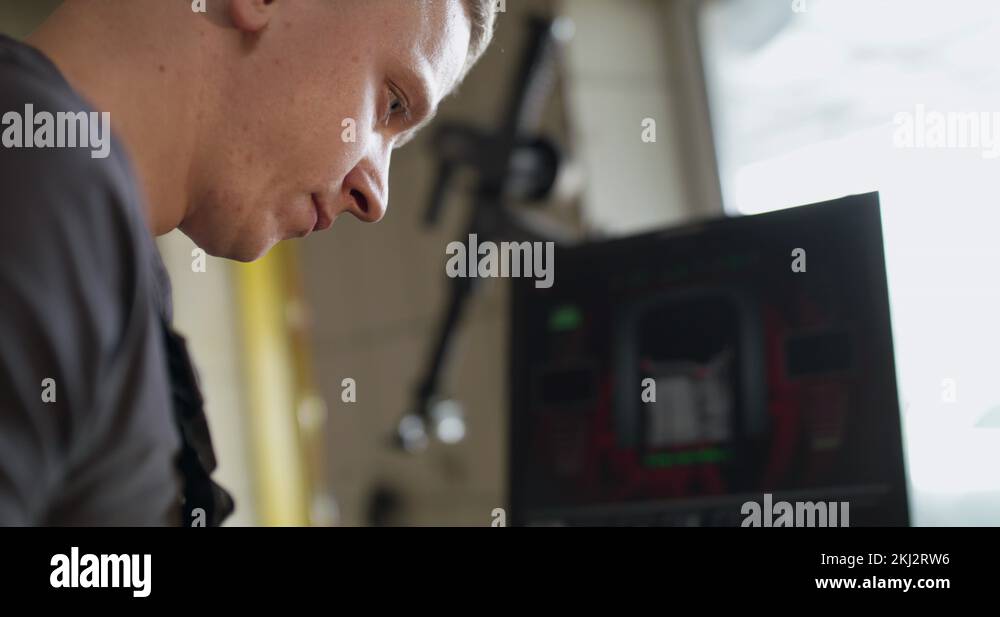 Mechanic controls a balance process on monitor in auto service Stock ...
