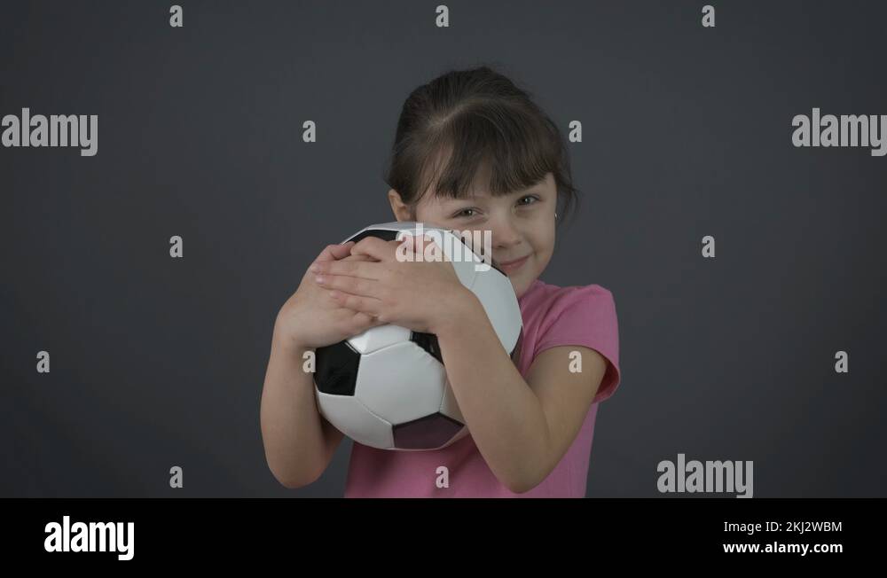 Little girl hugs a soccer ball Stock Video Footage - Alamy