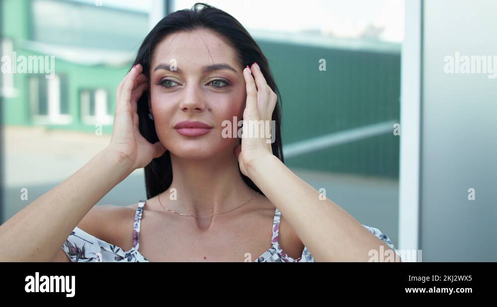 Stunning brunette flirting with her long hair at camera outdoors Stock ...