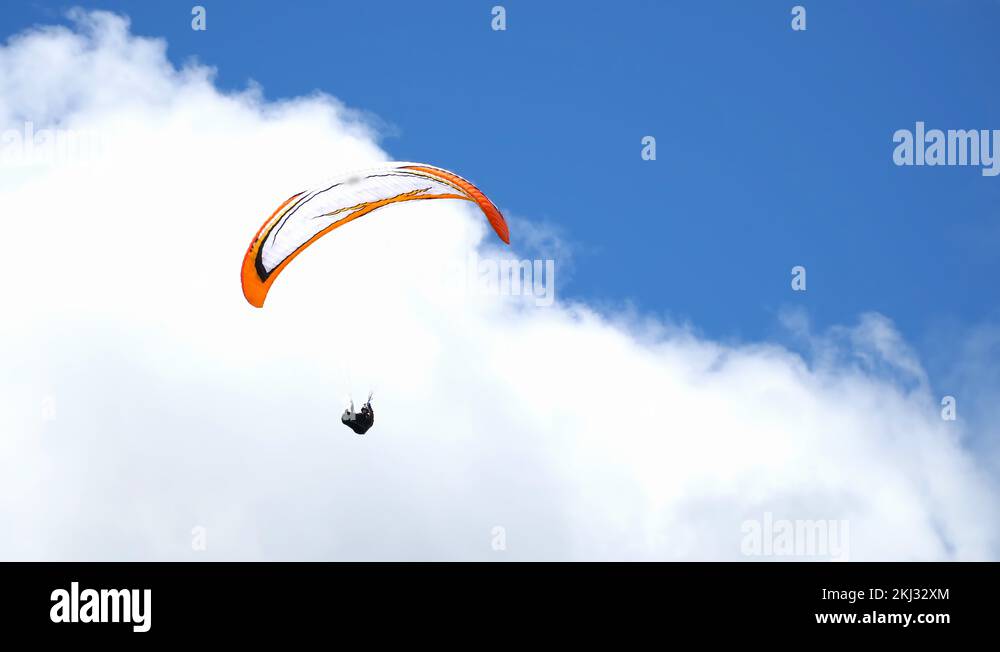 Paragliding in blue sky with clouds. Paraglider fly with parachute high ...
