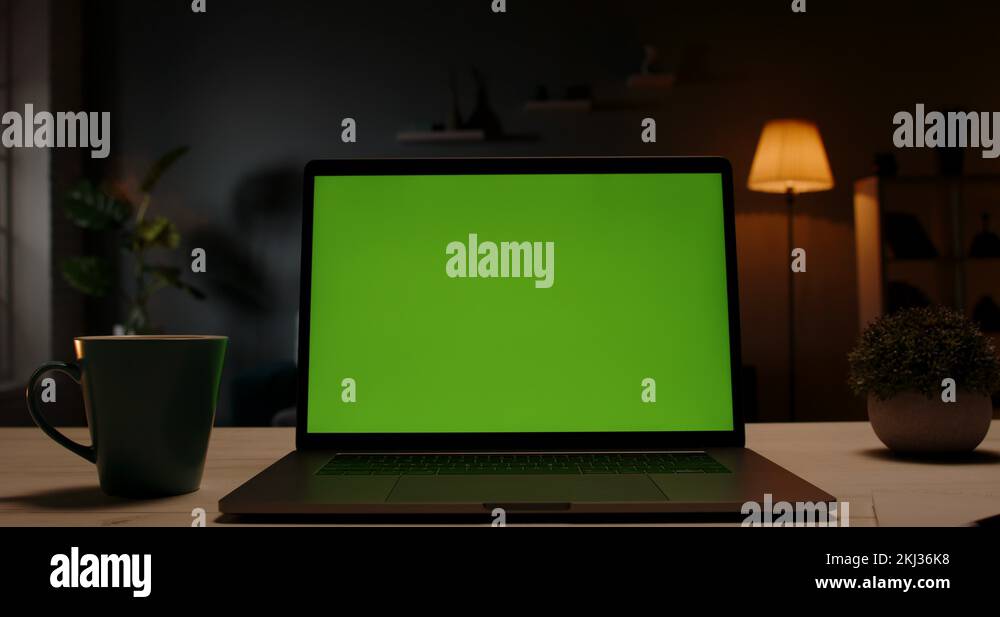 Chroma key green screen template - a laptop computer on a desk in cozy ...