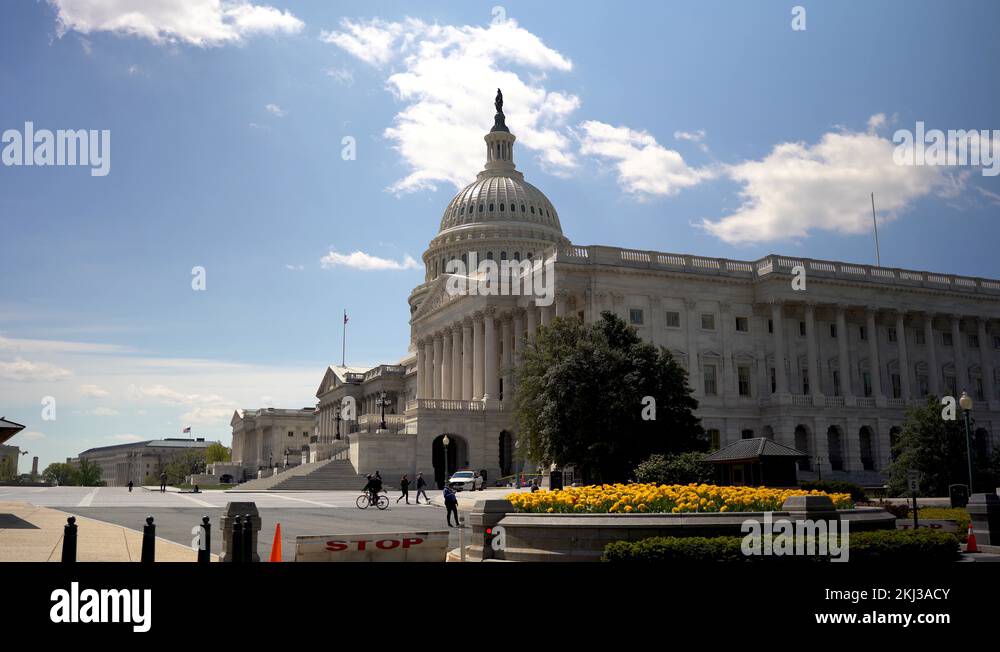 Motion to the left of the US Capitol shot from a diagonal angle on a ...