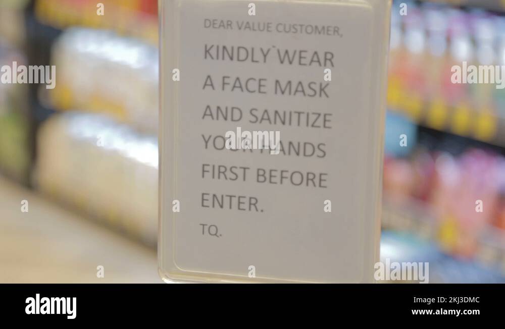 signage requesting customer to wear a face mask and sanitize hands ...