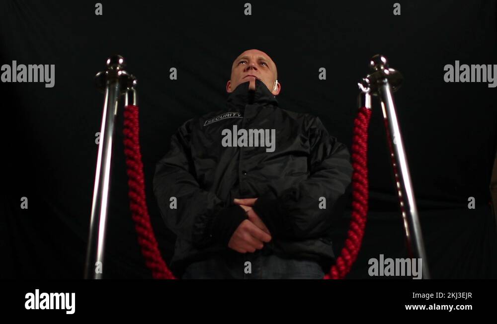 Bald Security Guard / Bouncer wearing black jacket Pointing at Camera ...