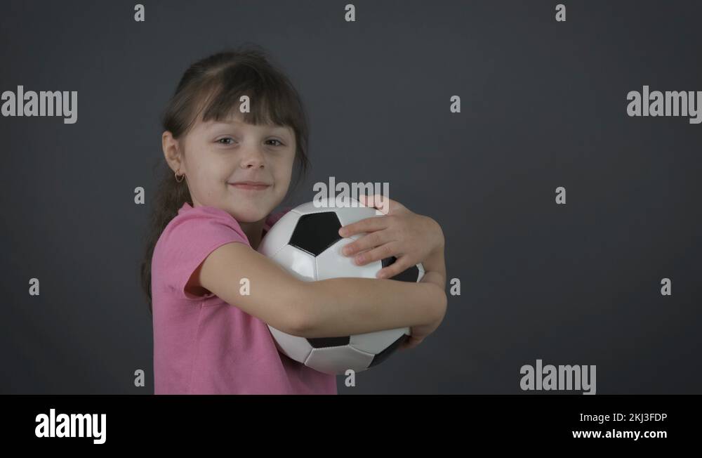 Cute little girl hugs a soccer ball Stock Video Footage - Alamy
