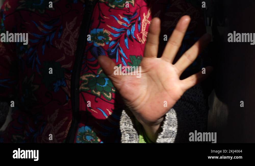 Chinese elderly woman in traditional dress waving hand to refuse Stock ...