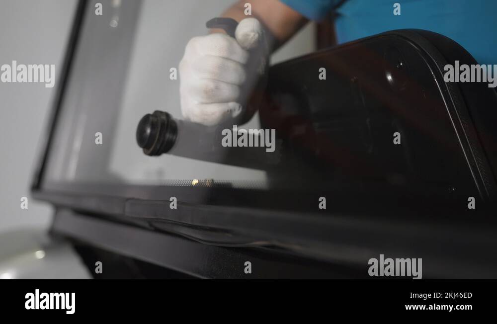 The driver opens the rear window on the tractor with the handle Stock ...