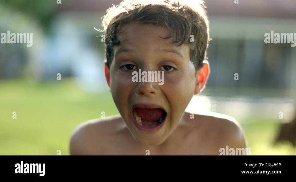 Kid reacting with horror and SHOCK by yelling and screaming to camera ...