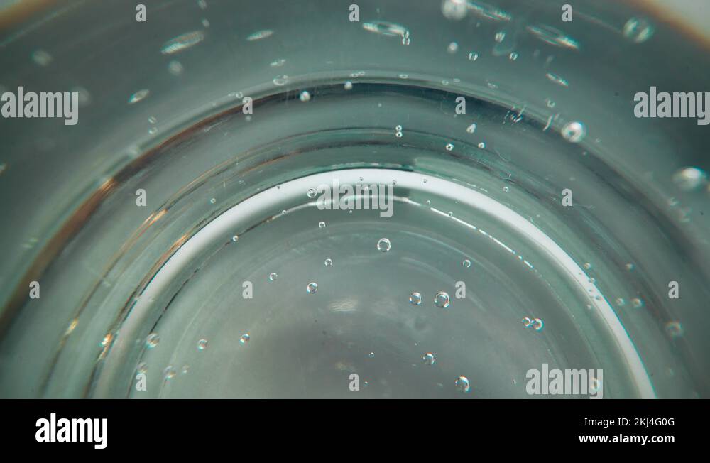 little bubbles float up inside sparkling water in glass Stock Video ...