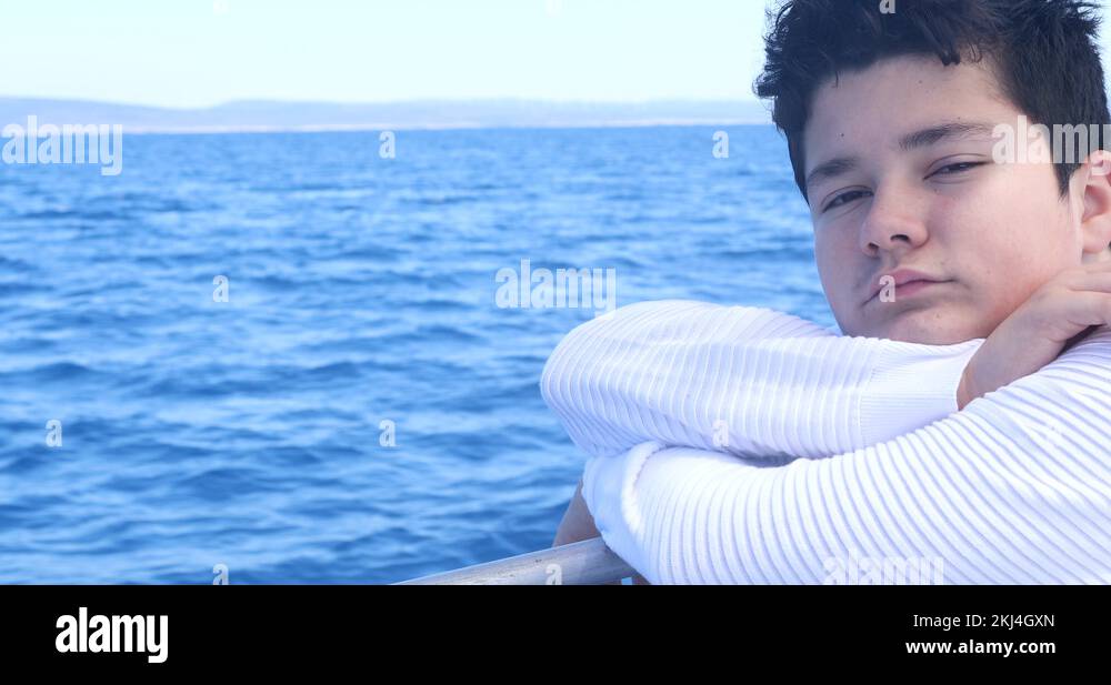 Sad young boy travelling by boat 3 Stock Video Footage - Alamy