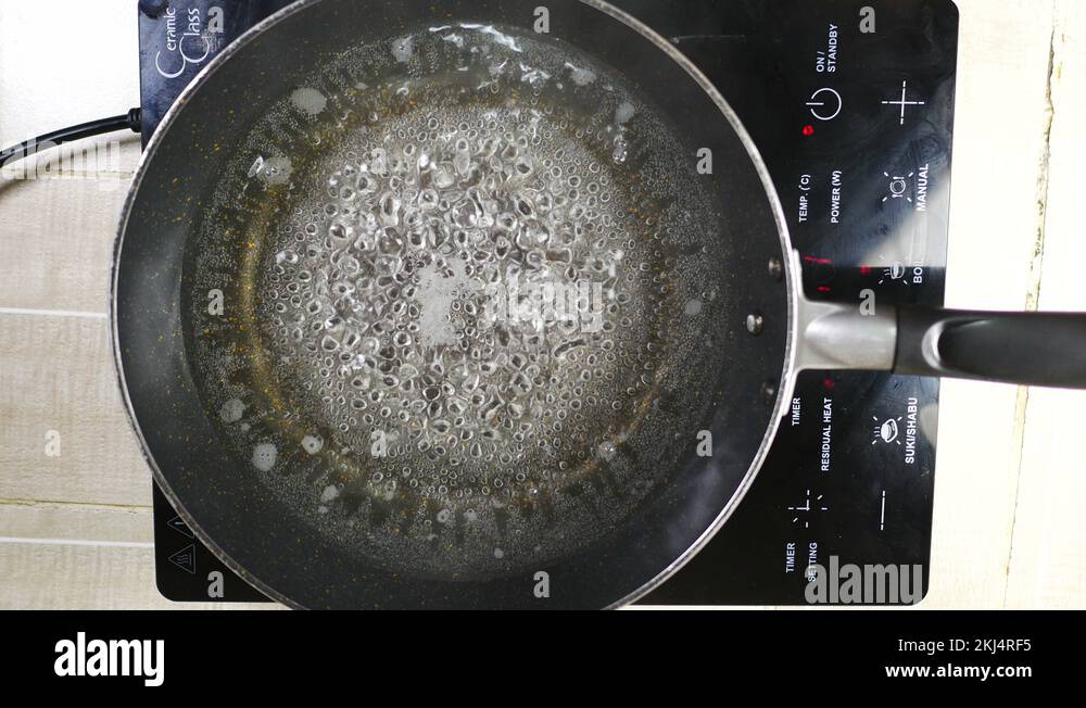 boiled water with bubble in teflon pan with smoke,red light indicator ...