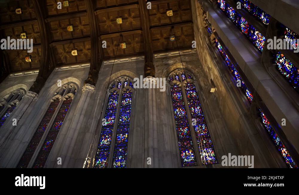 Cathedral ceiling with stained glass windows and wooden ceiling panels ...
