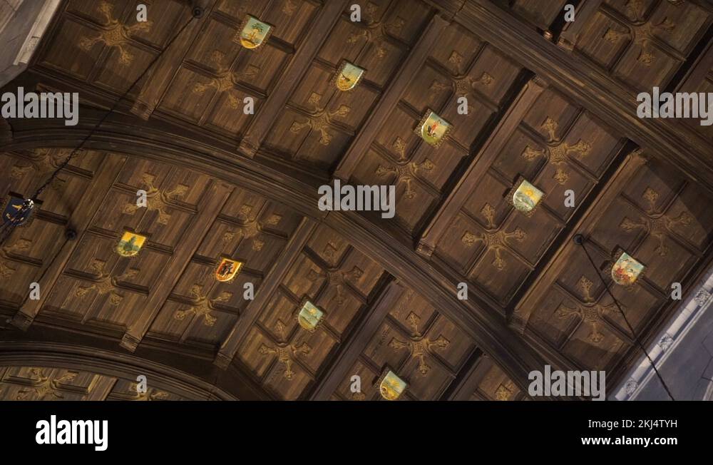 Arched wood paneled ceiling with heraldry and floral cruciform patterns ...