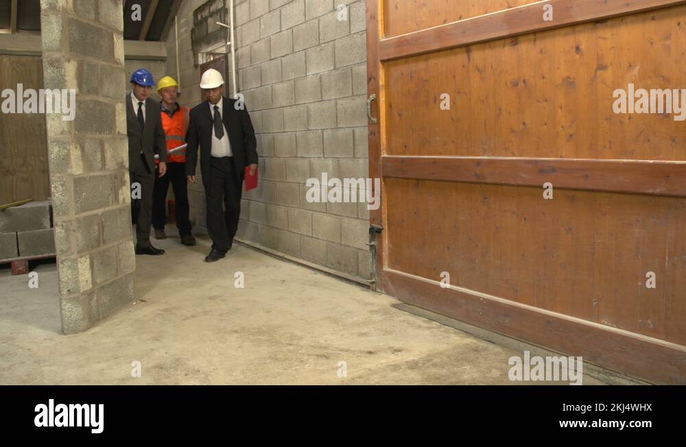 A Builder, Architect & Inspector are looking round Construction ...