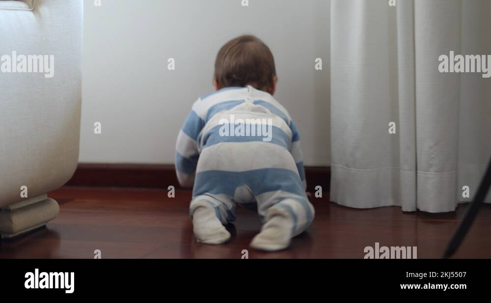 Cute baby boy standing up at home. Infant child learning development ...