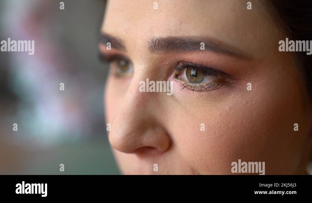 girl’s lips bite and eat red apple. The woman’s face is close-up, only ...