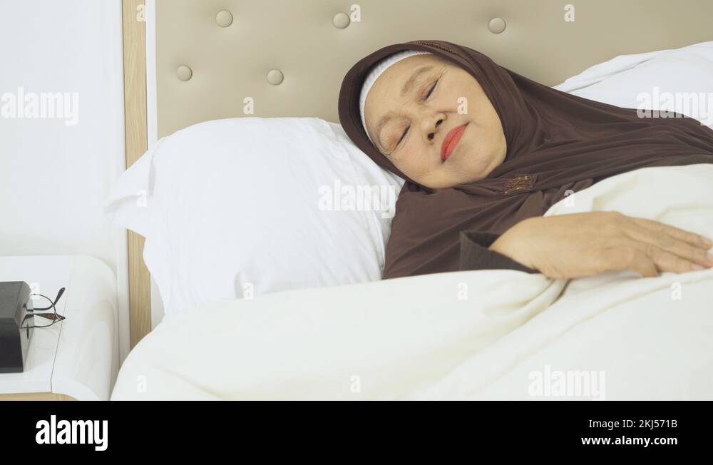 Old Muslim woman sleeping on the bed Stock Video Footage - Alamy