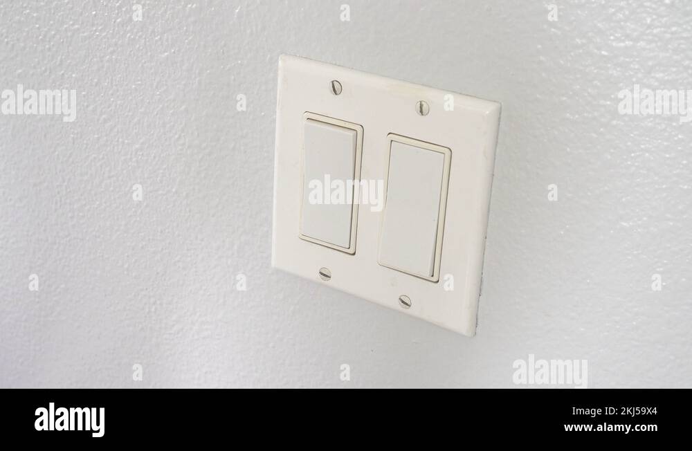 Painter Using Masking Blue Tape to Secure Light Switch. Preparation For ...