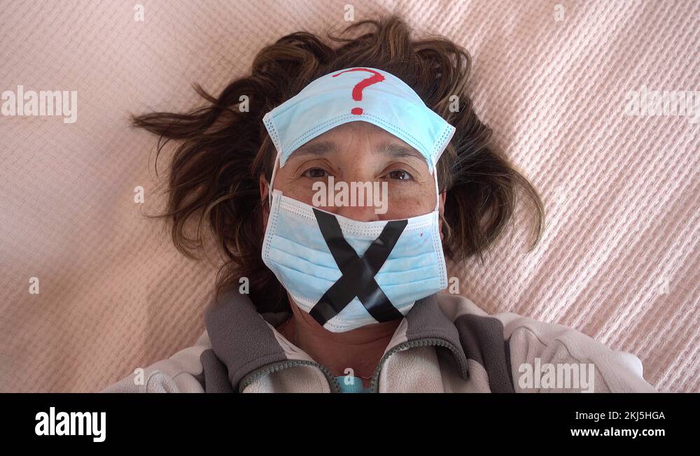 Woman in masks on bed with question and cross marks Stock Video Footage ...