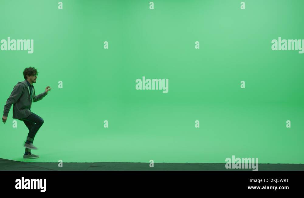 Green Screen Chroma Key Studio: Handsome Young Man Dances Across Room ...
