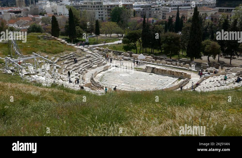 Pan from Theatre of Dionysus ancient theatre inside Acropolis to city ...