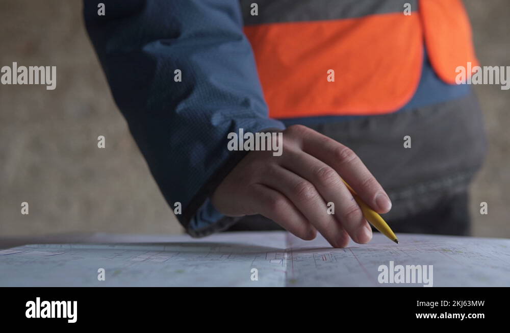 Civil engineer checks drawings at the construction site of a high-rise ...