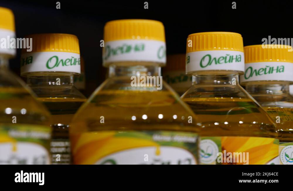 Plastic bottles with sunflower vegetable oil Oleina brand on shelves in ...