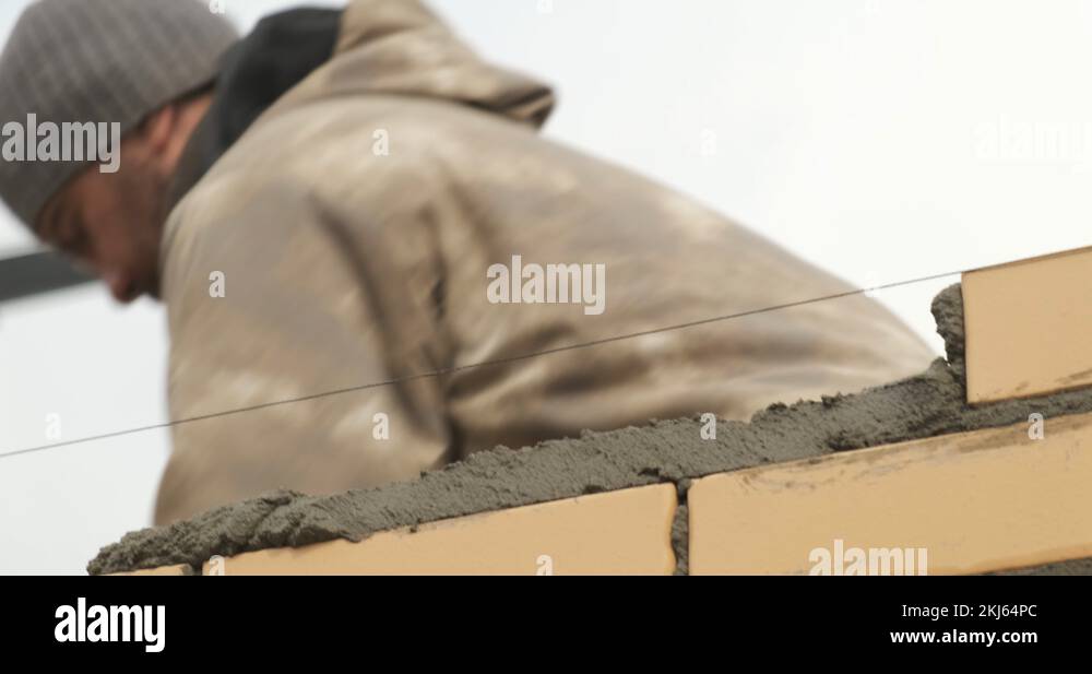 Bricklayer Takes on Hand Brick, Checks Integrity and Laying of Brick ...