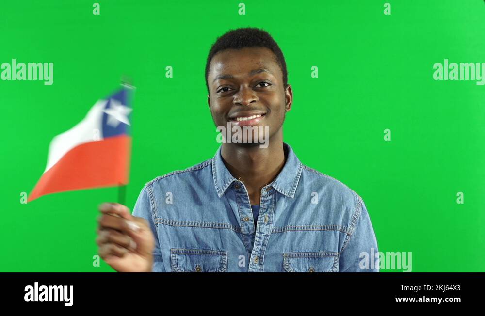 Young Man waving Chile hand Flag in front of Green Screen, Chroma Key ...