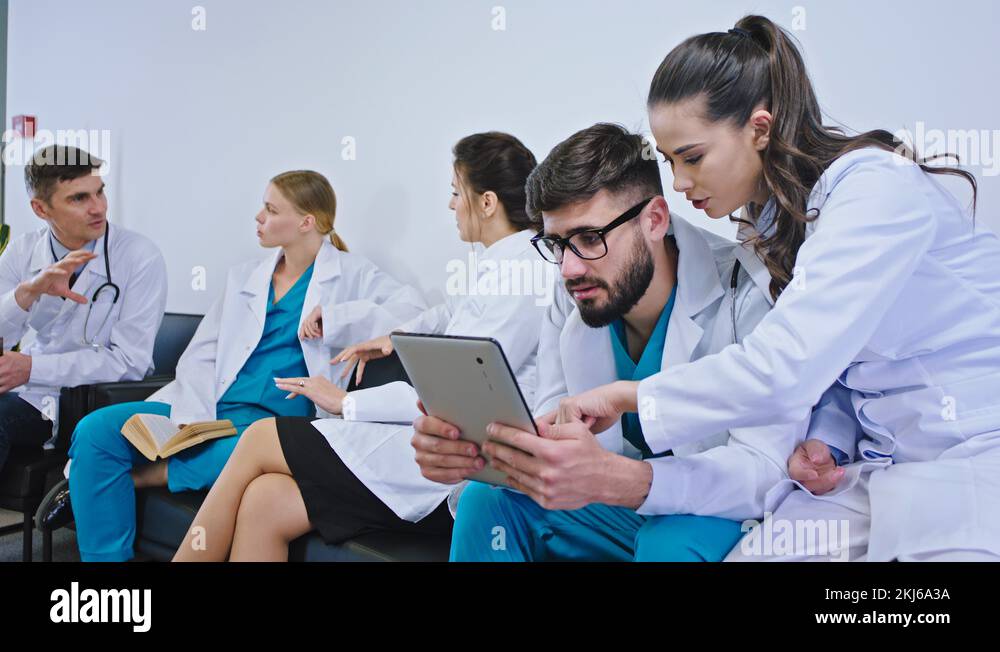 Modern hospital stuff room at the break time group of doctors and ...