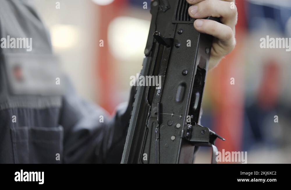 Factory assembly of a Kalashnikov assault rifle. Close up of charging ...