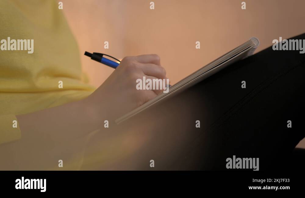 Lady woman sitting on the bed, write notes in his notepad. Stay home ...