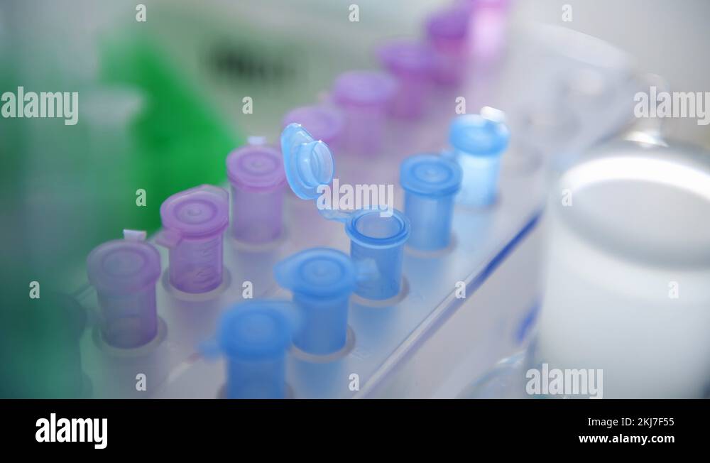 Scientist pipetting a sample into a vial ready for analytical testing ...
