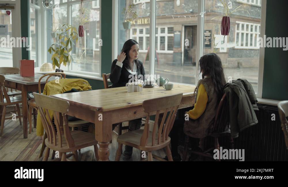 Mother and daughter leaving cafe Stock Video Footage - Alamy