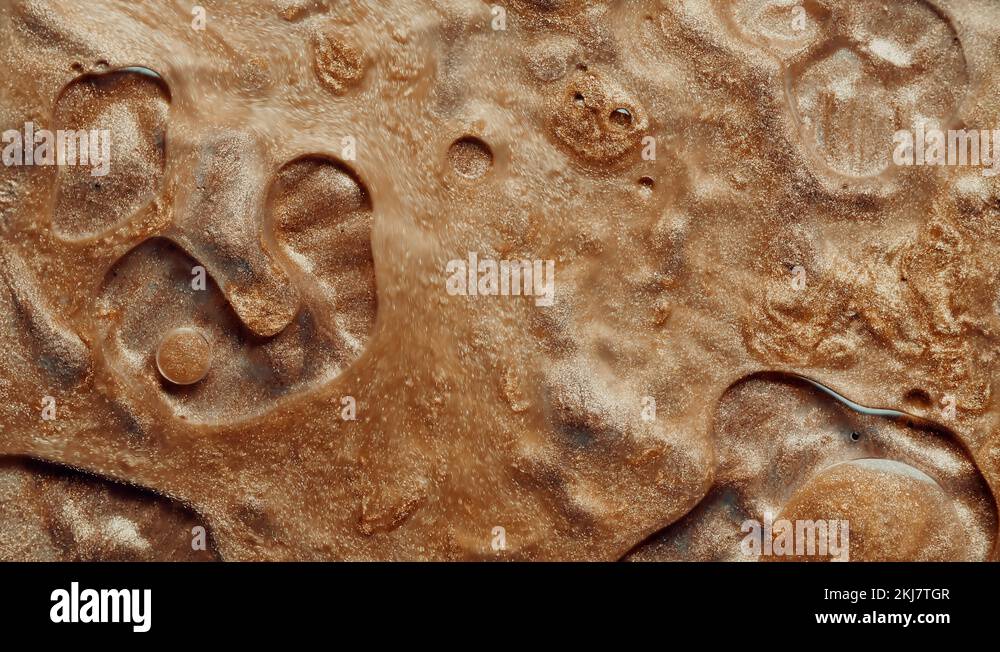 Gold and bronze paint flow mix in fantastic patterns. Liquid metal ...