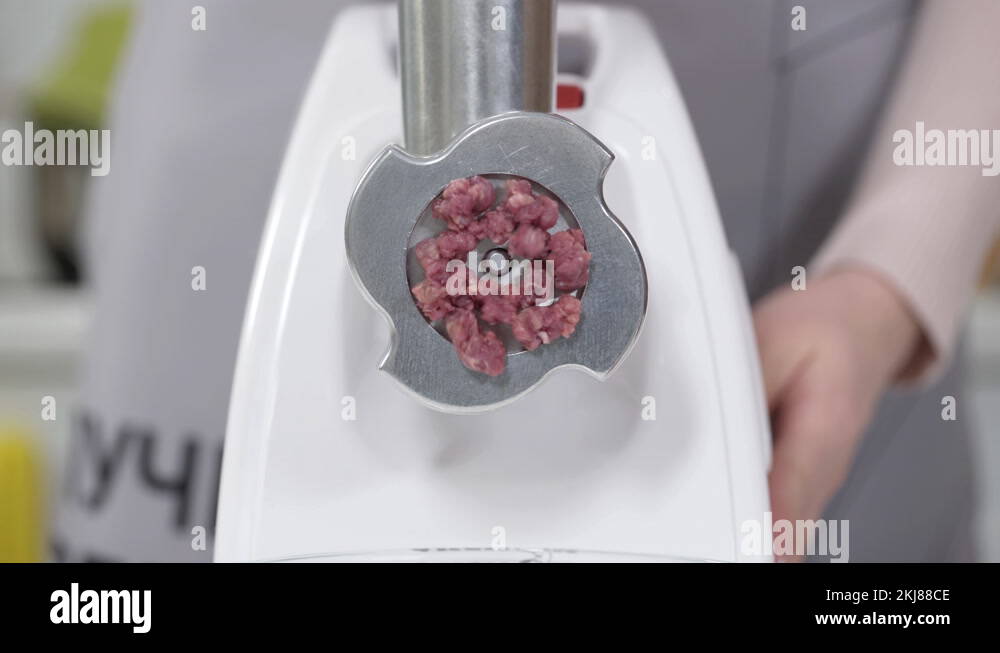 Making minced meat in an electric meat grinder from fresh beef at home ...