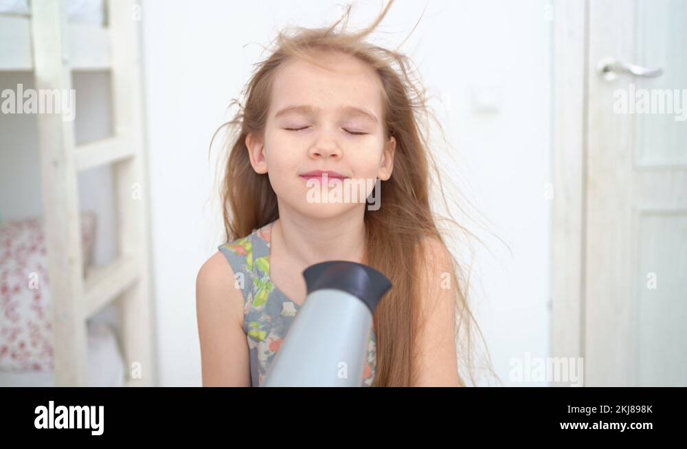 little girl drying her long hair with hair dryer Stock Video Footage ...