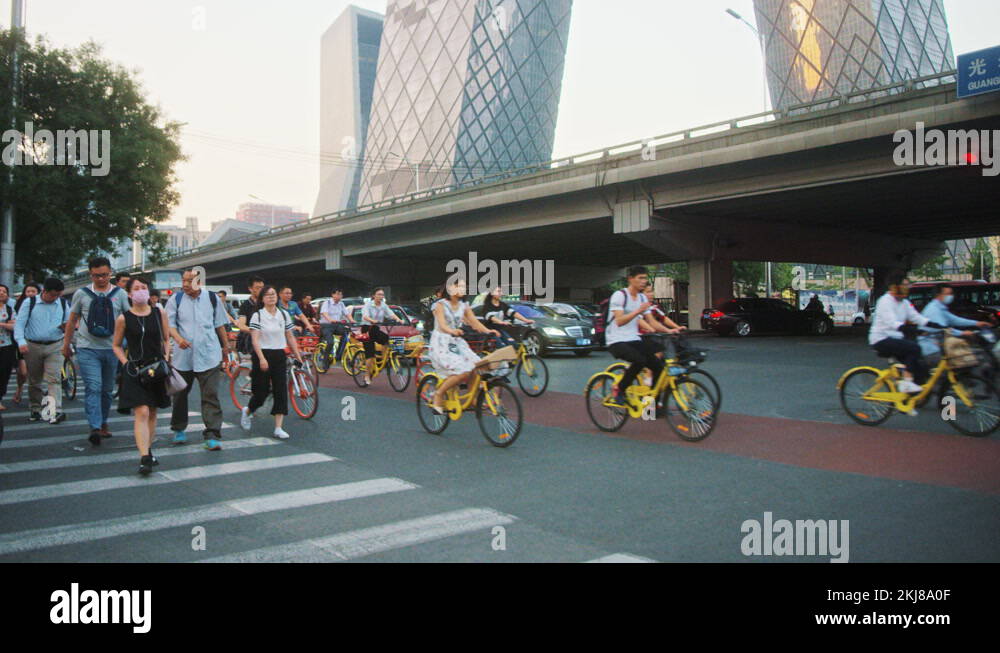 Crowd of Chinese women and men cross crosswalk at green light of ...