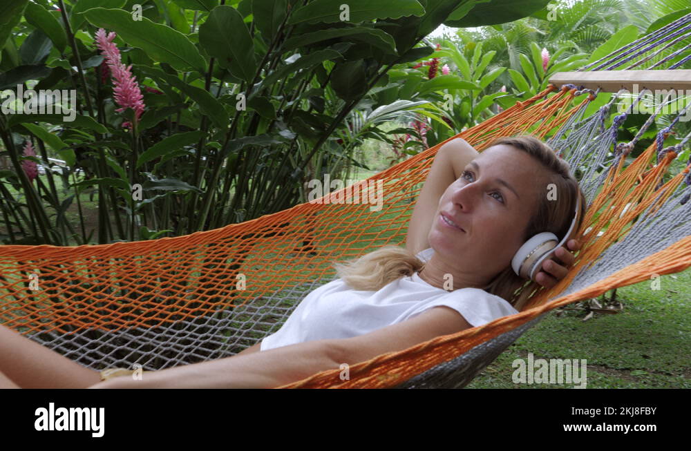 Girl listening to music in hammock Stock Video Footage - Alamy