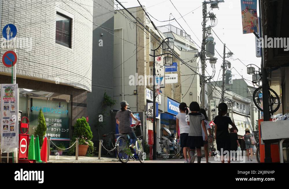 Tokyo - Small quiet lane with people walking and cycling. 4K resolution ...