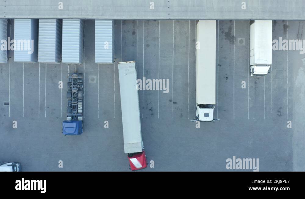 Aerial top down view of the semi truck with cargo trailer at a ...