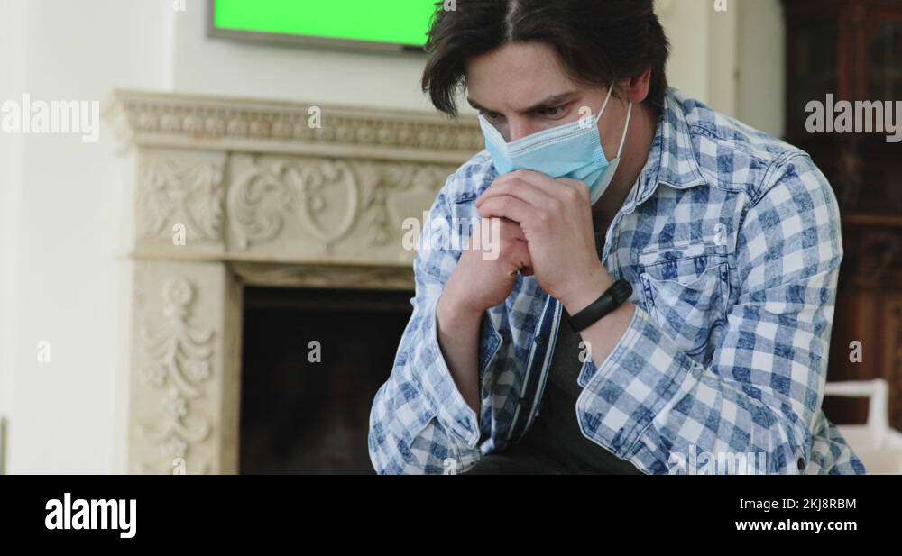 Sad man in mask isolated at home, goes crazy at tv plasma with green ...