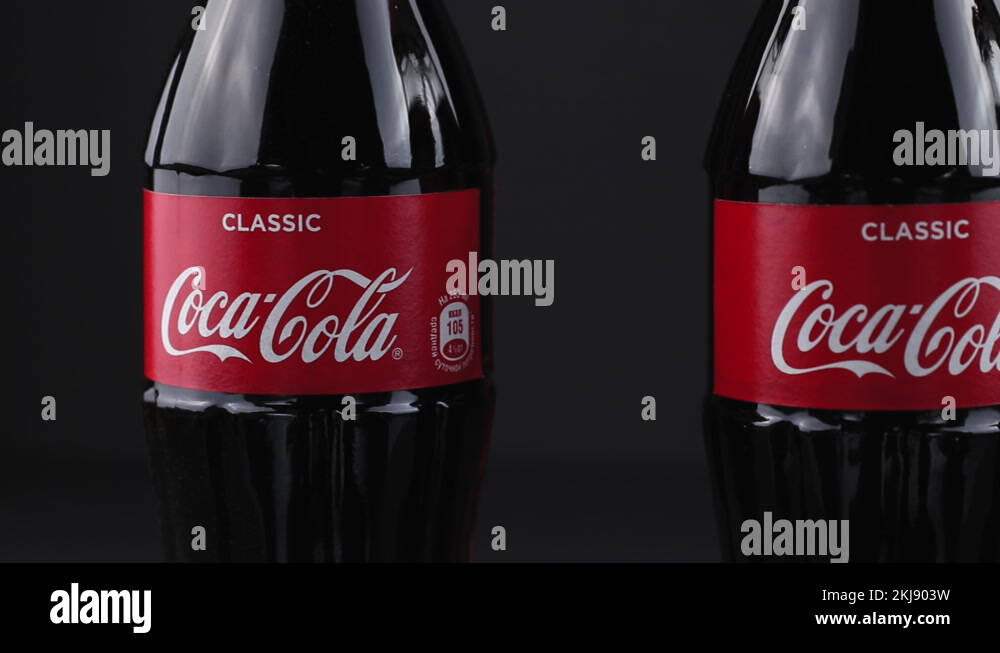 Three glass bottles with red coca-cola classic logo close up Stock ...